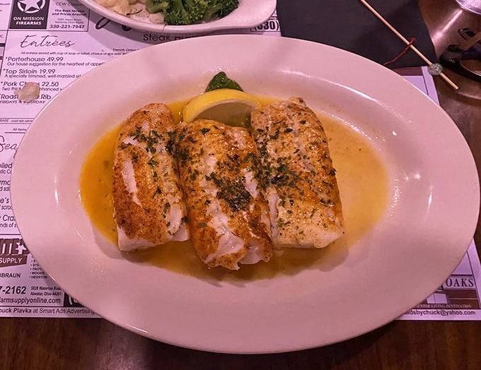 Broiled cod swimming in butter and herbs—proof that Arnie's mastery extends well beyond the pasture to the depths of the sea.