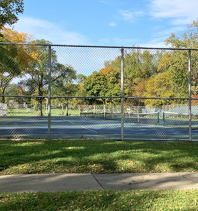 Tennis, anyone? These courts await friendly volleys and competitive matches alike, surrounded by trees that provide nature's perfect spectator seating.