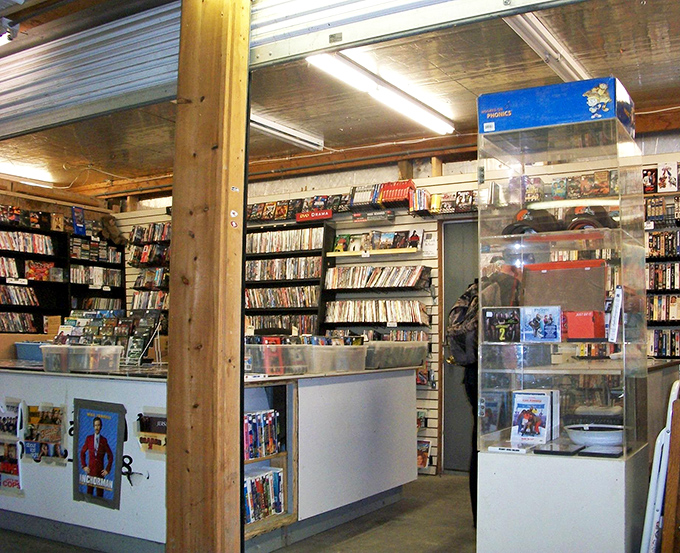 Physical media finds sanctuary in this analog oasis of entertainment. DVDs and CDs line shelves like an archaeological dig through recent pop culture history.