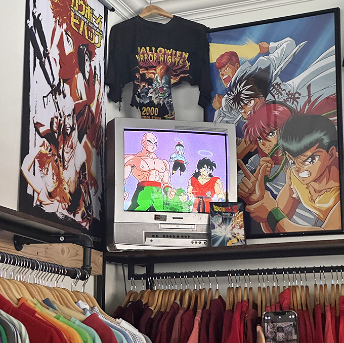 A nostalgic corner featuring anime art and a vintage TV playing Dragon Ball Z. For 90s kids, this spot hits harder than finding money in an old coat pocket.