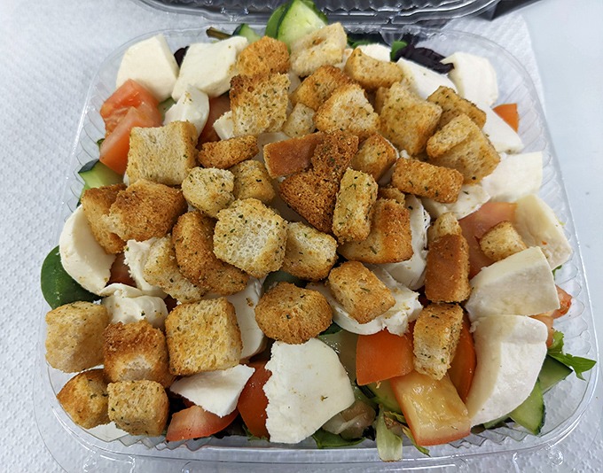This isn't just a salad—it's a strategic arrangement of freshness, where each crouton is a crunchy island in a sea of green possibility.