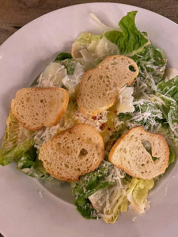 A Caesar salad that respects tradition&mdash;crisp romaine, shaved cheese, and croutons that crackle like autumn leaves. Simple pleasures done right.