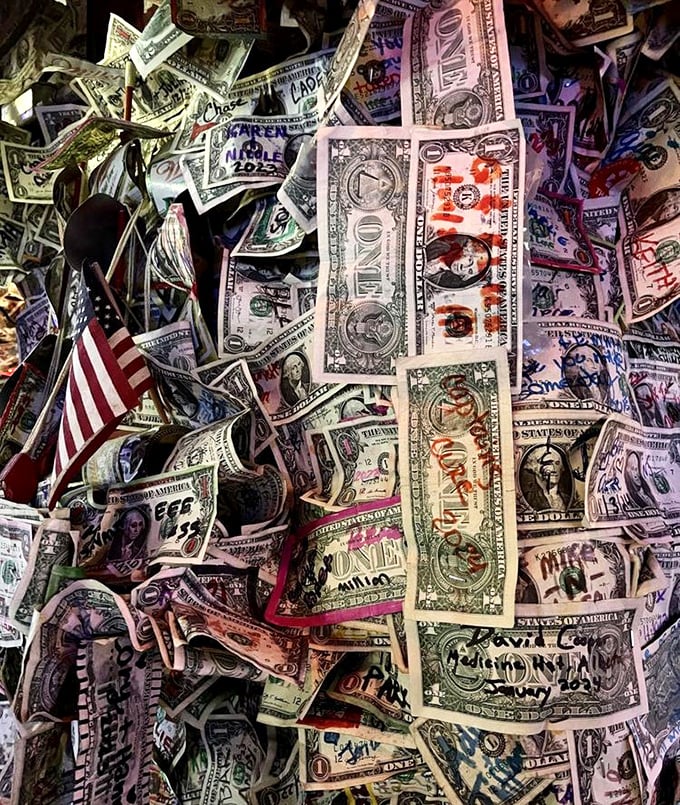 Look closely at the dollar bills and you'll find love notes, anniversaries, and declarations from visitors determined to leave their mark.