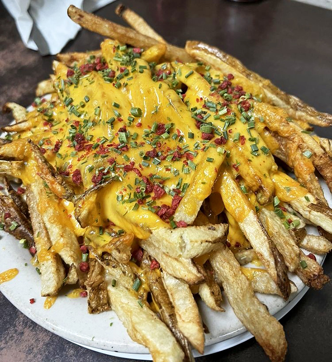 These aren't just cheese fries&mdash;they're a masterpiece of crispy potato, melted cheese, and garnishes that would make an art critic weep.
