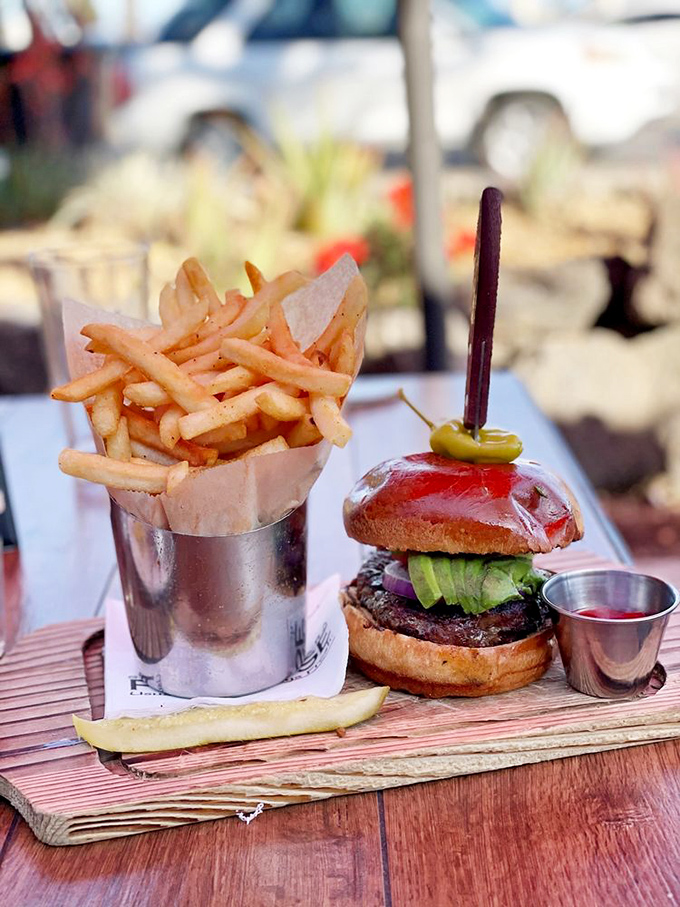 A burger that didn't get the memo this is a seafood joint. Those fries standing at attention in their metal cup salute your good taste.