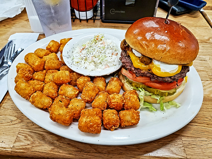 This isn't just a burger&mdash;it's a towering monument to American excess, complete with golden tater tots standing guard like delicious sentries. 