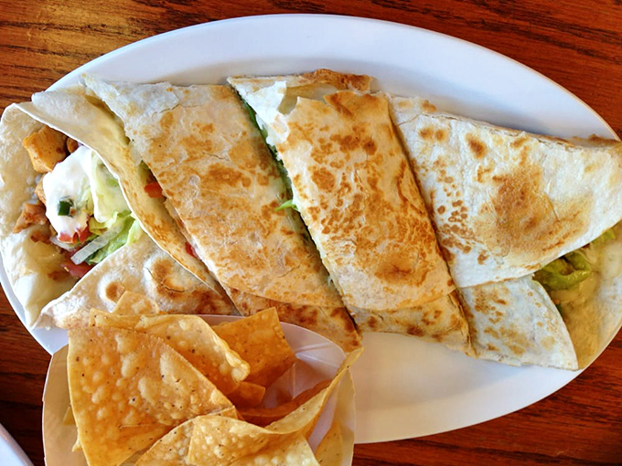 The quesadilla&mdash;that perfect marriage of crispy tortilla and molten cheese&mdash;sliced with the precision of a diamond cutter.