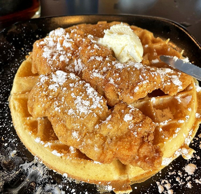 The holy grail has arrived &ndash; golden chicken atop a perfect waffle with a dusting of powdered sugar that's worth every calorie.
