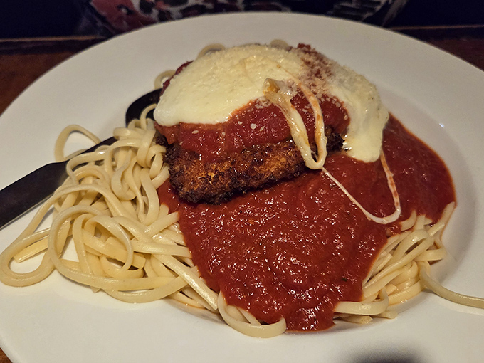 Chicken Parmesan that doesn't mess around&mdash;crispy cutlet, tangy marinara, and melted cheese atop a bed of pasta that knows its supporting role.