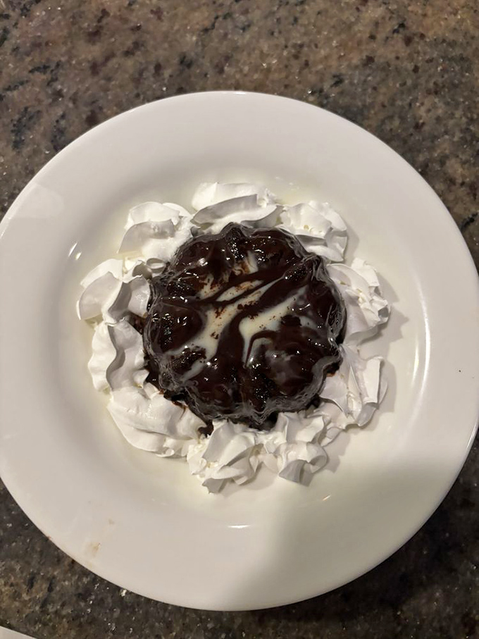 Chocolate lava cake surrounded by whipped cream—because after conquering seafood, you deserve a victory lap of molten chocolate decadence.