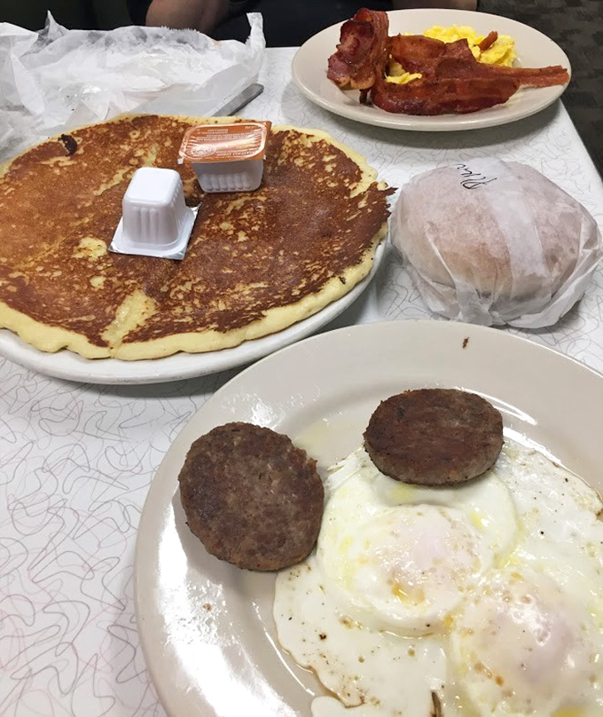 This breakfast spread could feed a small army—or one very determined hungry person. That pancake is practically the size of a manhole cover!
