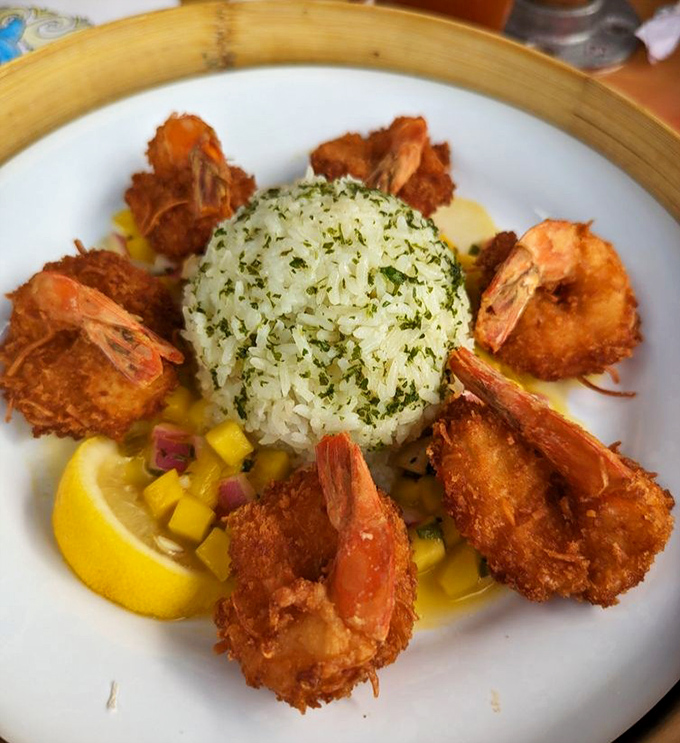 Coconut shrimp arranged like edible flowers around herb-kissed rice &ndash; when presentation meets pure deliciousness.
