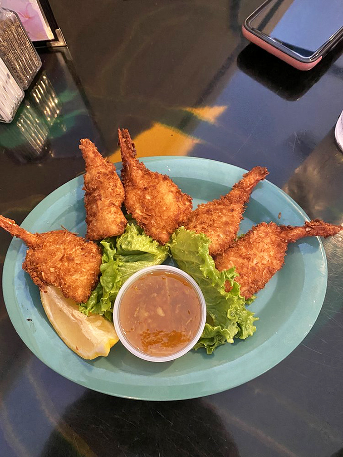 Coconut shrimp with tails reaching skyward like they're trying to escape your plate&mdash;but that golden crust and sweet dipping sauce ensure they won't get far.