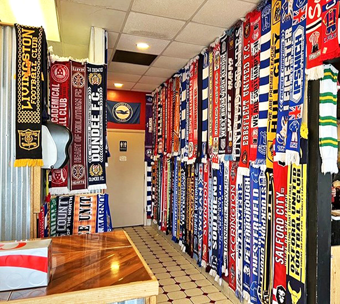 A colorful tapestry of football scarves lines the wall&mdash;each one telling stories of matches, pints, and passionate fans.