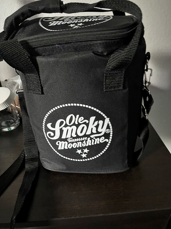 Carrying your mountain spirits home just got easier! This branded cooler bag ensures your moonshine makes it safely from Gatlinburg to your own back porch.