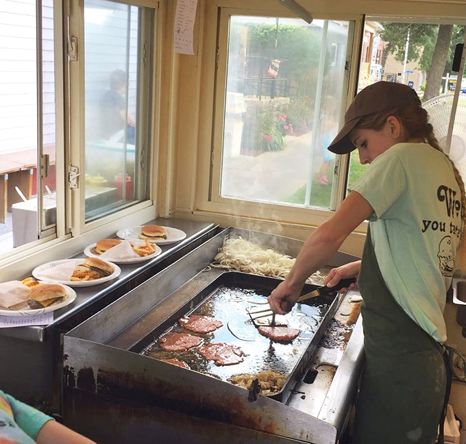 The magic happens on this well-seasoned flat top, where burger patties are smashed into thin, crispy-edged perfection by practiced hands.