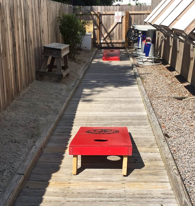 Cornhole boards offer the perfect between-bites entertainment – because nothing pairs with seafood like friendly competition and questionable throwing skills.