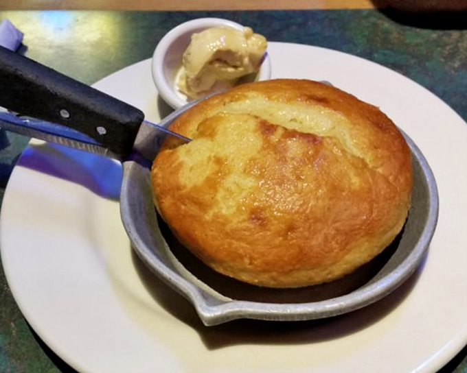 Cornbread served in a hot skillet with a side of butter that's melting faster than your willpower &ndash; a Southern tradition that feels like a warm hug.