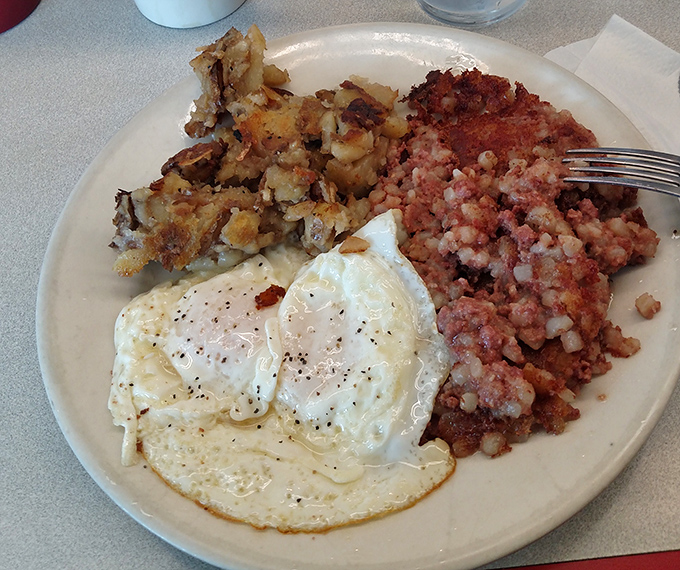 The holy trinity of breakfast: perfectly cooked eggs, crispy home fries, and corned beef hash with the ideal meat-to-potato ratio. No filter needed.