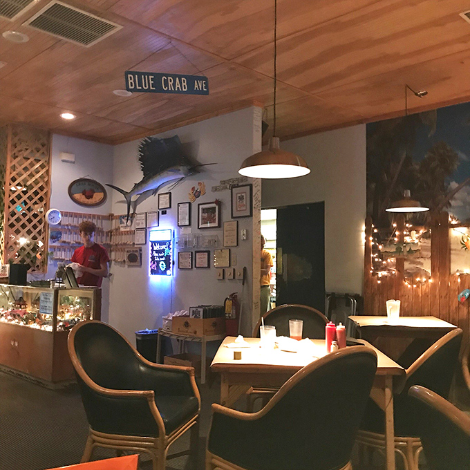 Another dining area showcases maritime treasures and the signature "Blue Crab Ave" sign&mdash;casual elegance with a side of coastal charm.
