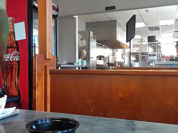 Simple wooden booths and Coca-Cola signs&mdash;the universal language of "good food happens here" that needs no translation.