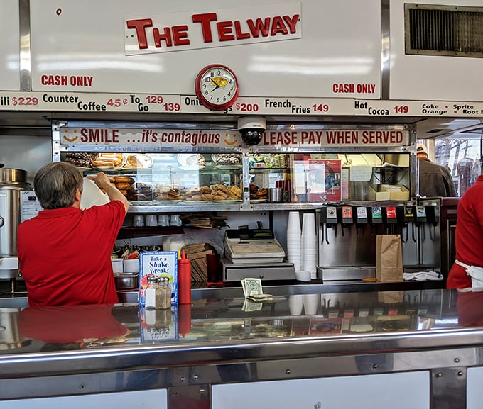 SMILE...it's contagious reads the sign, as if anyone could frown while watching donuts and sliders being prepared with such dedication.