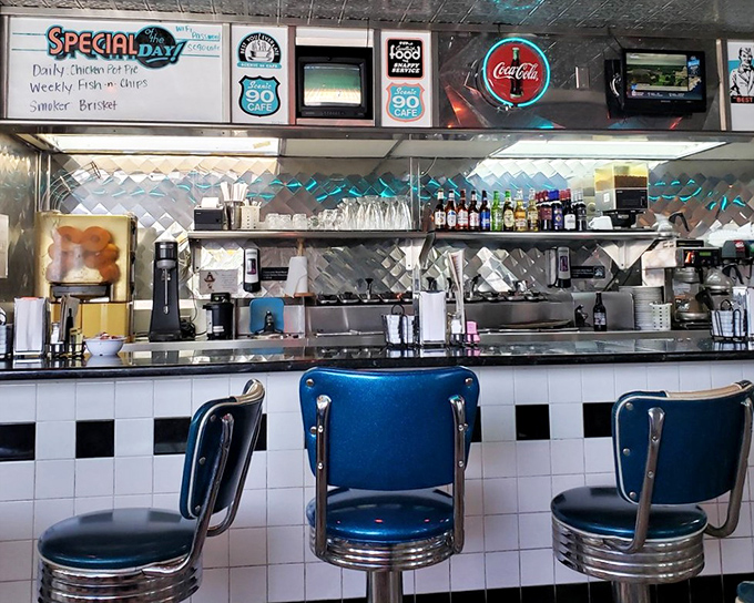 Behind the counter, where the real magic happens amid chrome, Coca-Cola signs, and decades of perfected recipes.