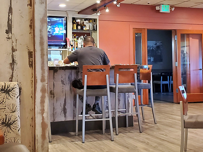 The bar area offers counter seating for solo diners or those who appreciate the choreographed ballet of a busy restaurant kitchen.