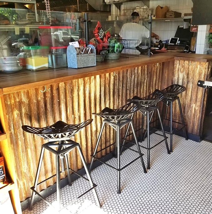 Rustic corrugated metal meets modern design at this counter where you can watch barbecue magic happen in real time.