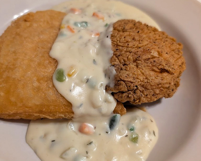 Country fried steak swimming in creamy vegetable-studded gravy &ndash; when a dish requires both a fork and a spoon, you know you're in for something special.
