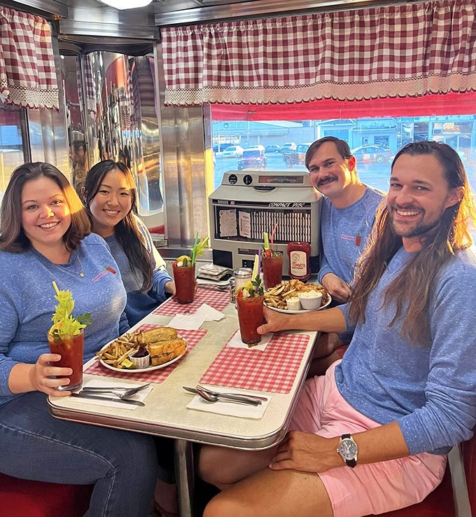 Happy diners raising their Bloody Marys in a toast to good food and even better company in this classic American setting.