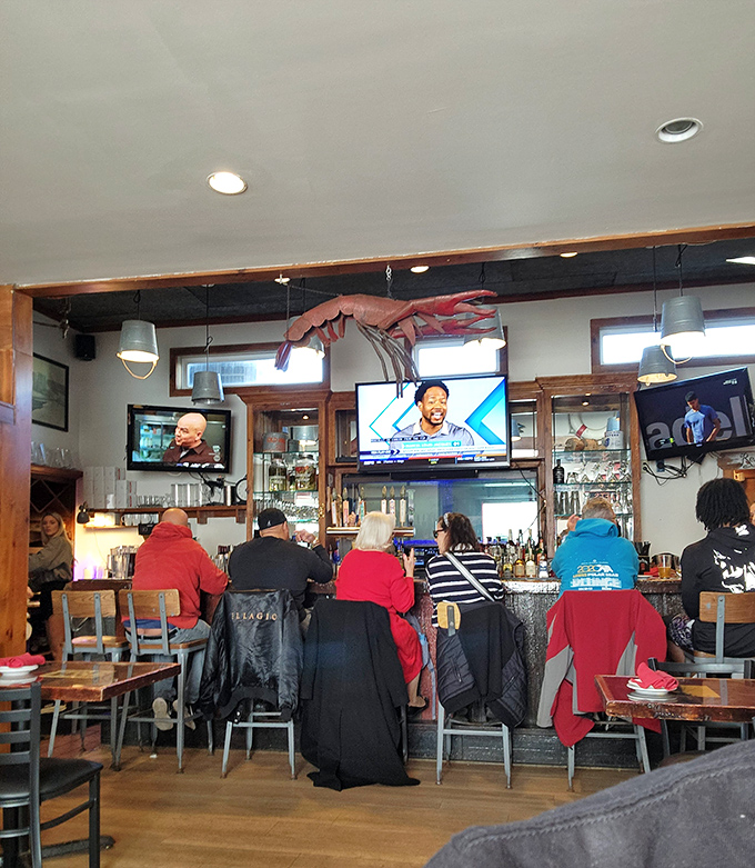Where locals and visitors unite in the pursuit of seafood excellence. The giant crab suspended above watches approvingly over the proceedings.