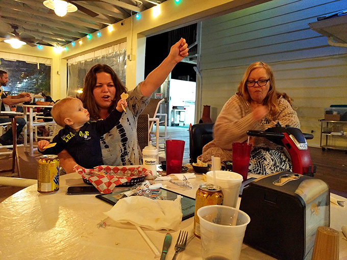 Nothing says "this place is good" like happy diners enjoying a family meal. That raised fork signals victory in the quest for great seafood.