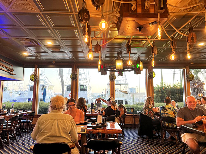 The dining room hums with happy conversations as patrons enjoy their meals with a side of boat-watching through panoramic windows.