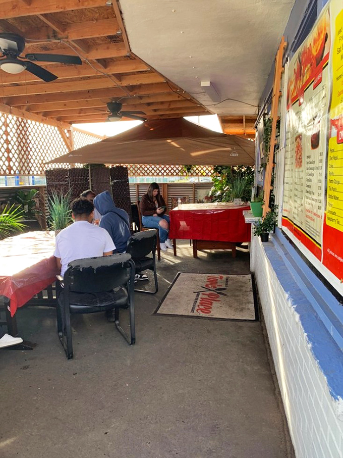 The covered patio offers a casual, relaxed atmosphere where diners can enjoy their meals while soaking in the unpretentious charm of this neighborhood favorite.