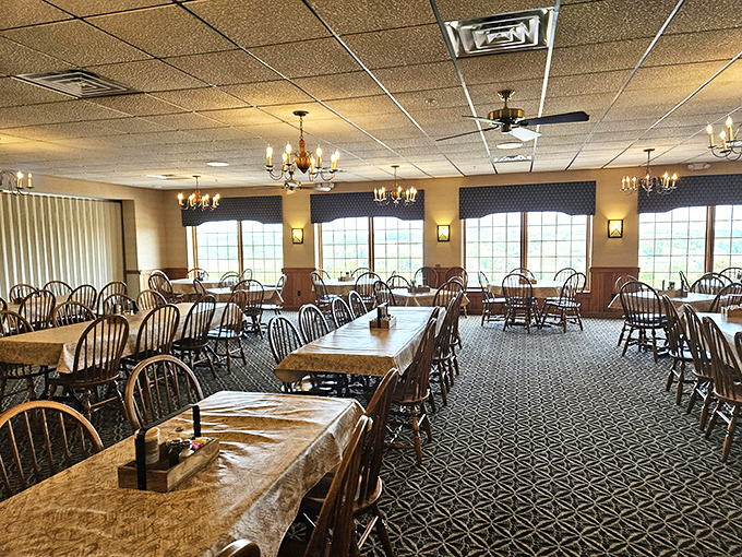 Windows frame the pastoral landscape like living paintings, while tables await the parade of platters. This room has witnessed more food joy than a thousand Instagram influencers.