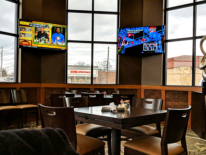 Floor-to-ceiling windows flood the dining area with natural light, while TVs ensure you won't miss a single play.