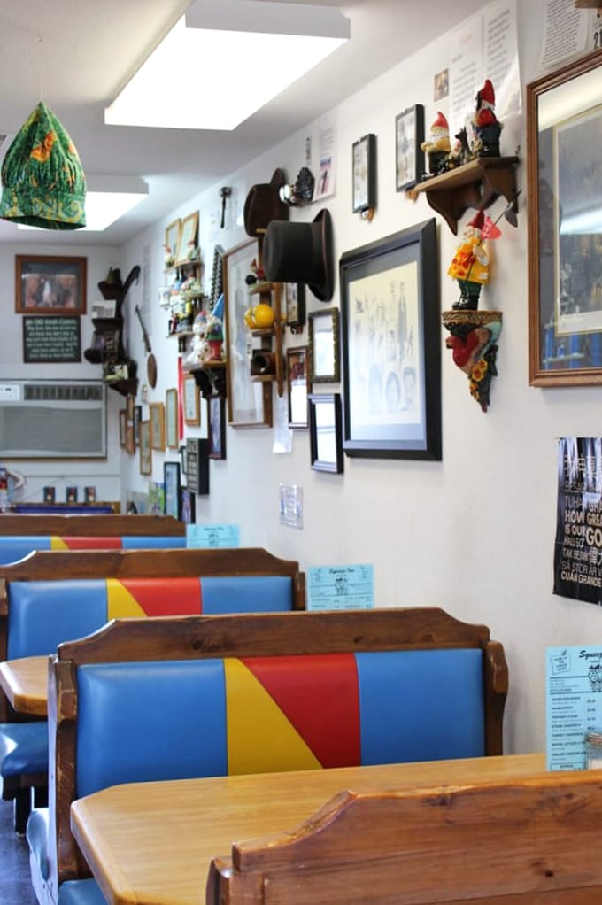 The colorful booth seating pops against rustic wood tables. Every wall is a gallery of local history, making each visit a cultural experience.