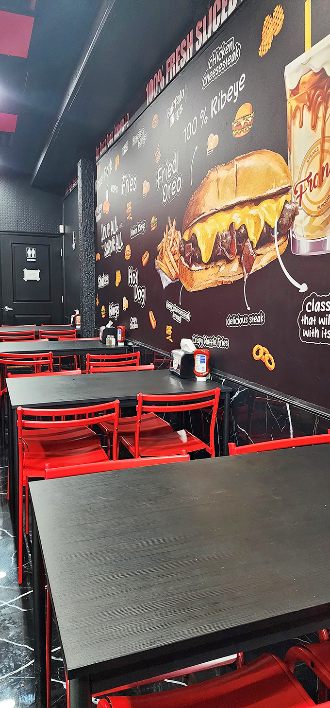 Bold red chairs against food-celebrating murals. The dining area's design makes one thing clear: you're here for serious eating, not fancy atmosphere.