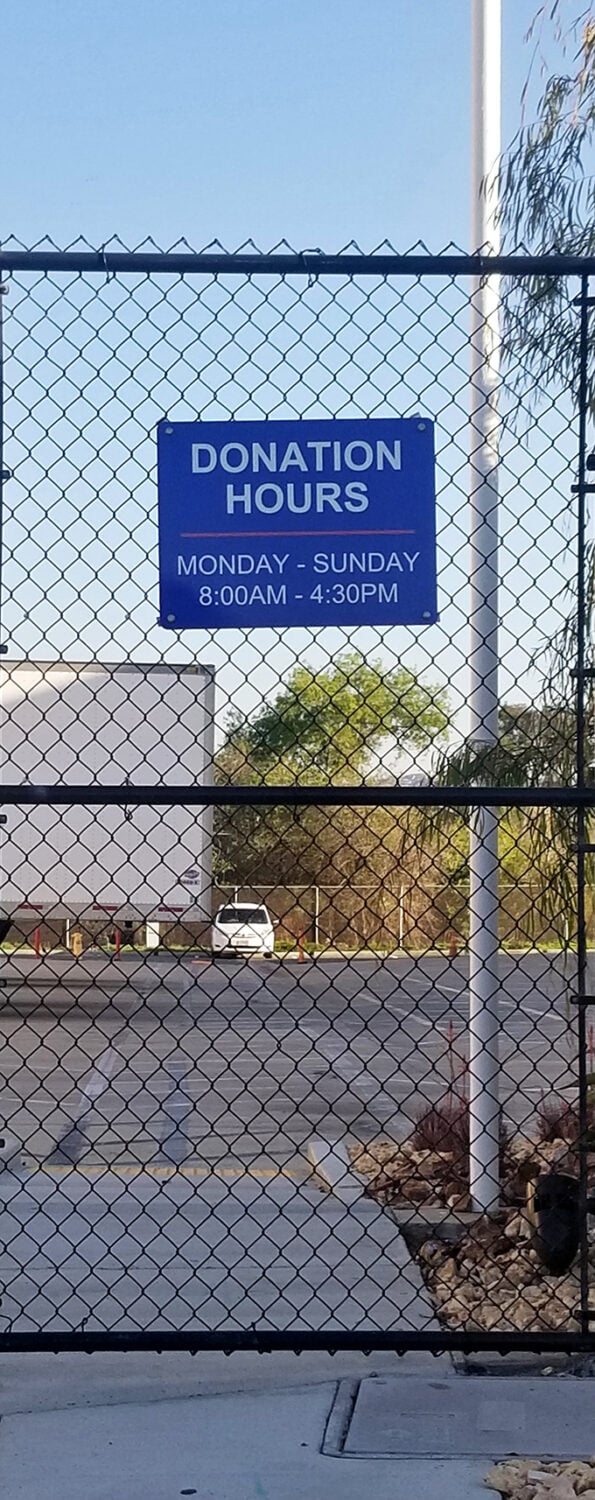 Donation hours posted clearly, reminding us that today's spring cleaning becomes tomorrow's treasure hunt.