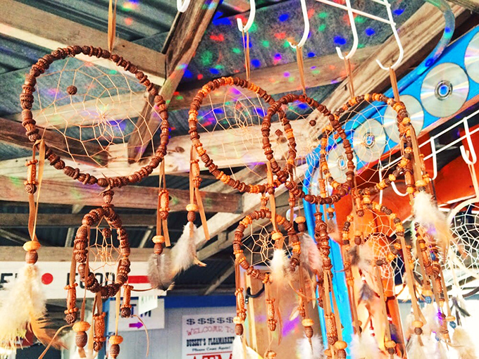 Dreamcatchers dance from rustic rafters, their wooden beads and feathers swaying gently like wind chimes for the eyes.