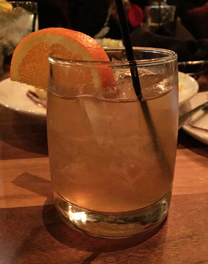 The Early Riser cocktail with its citrus garnish &ndash; because sometimes the perfect Manhattan needs a Southern vacation.