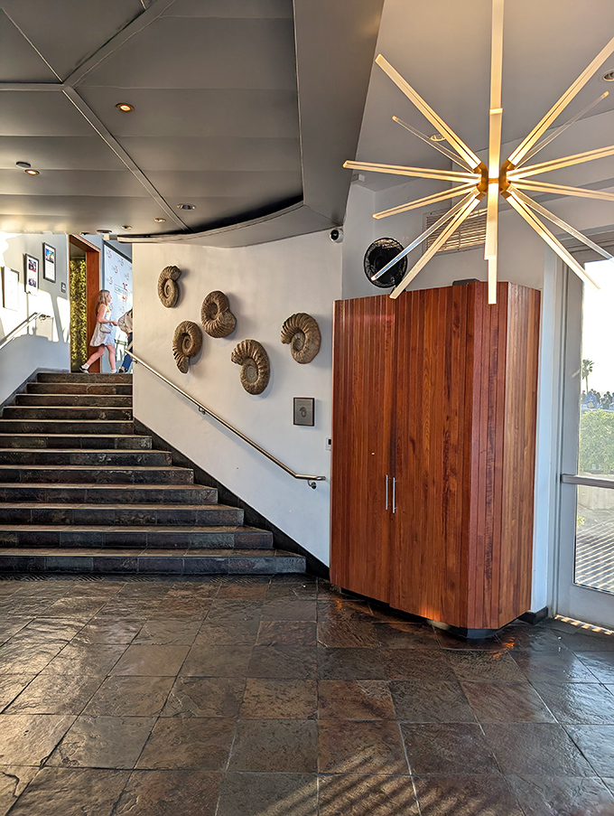 The entrance welcomes guests with clean lines and warm wood, setting expectations for the refined experience awaiting upstairs.