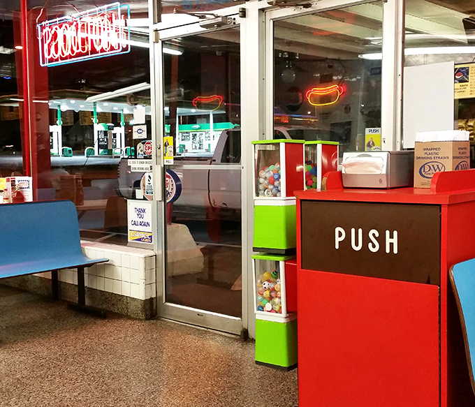 That "PUSH" door might as well say "ENTER HAPPINESS." The neon hot dog sign glows like a beacon of hope in a world of complicated dining options. 