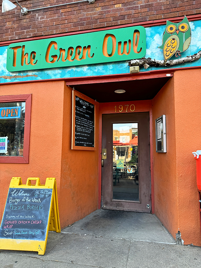 The entrance beckons with its cheerful orange facade and signature owl, like a portal to a more colorful culinary dimension.