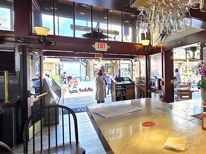 The restaurant's entrance frames the bustling pier outside, creating a perfect transition from tourist to treasured diner.