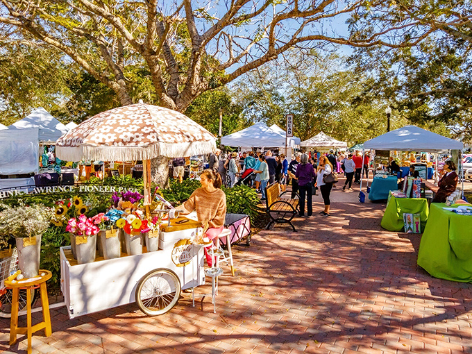 Flower carts and vendor tents create an instant community where strangers bond over handcrafted soaps and the shared belief that everything smells amazing.