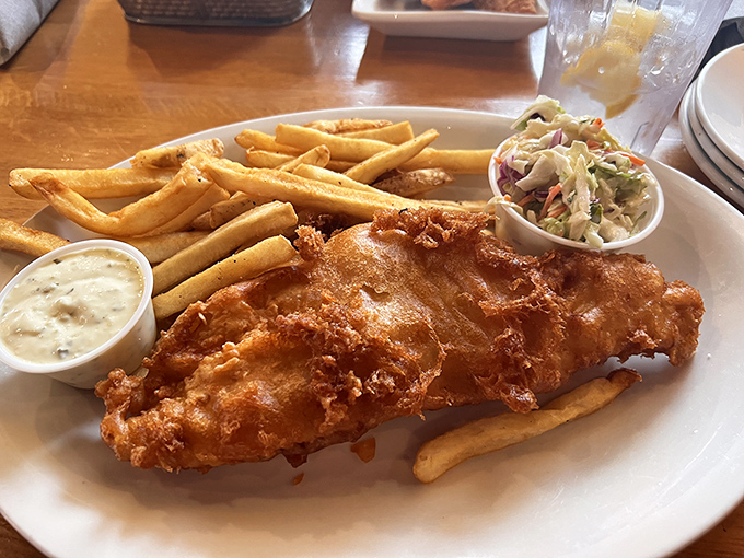 Fish and chips that achieve the golden ratio of crispy exterior to flaky interior, served with enough fries to make you question your life choices deliciously.