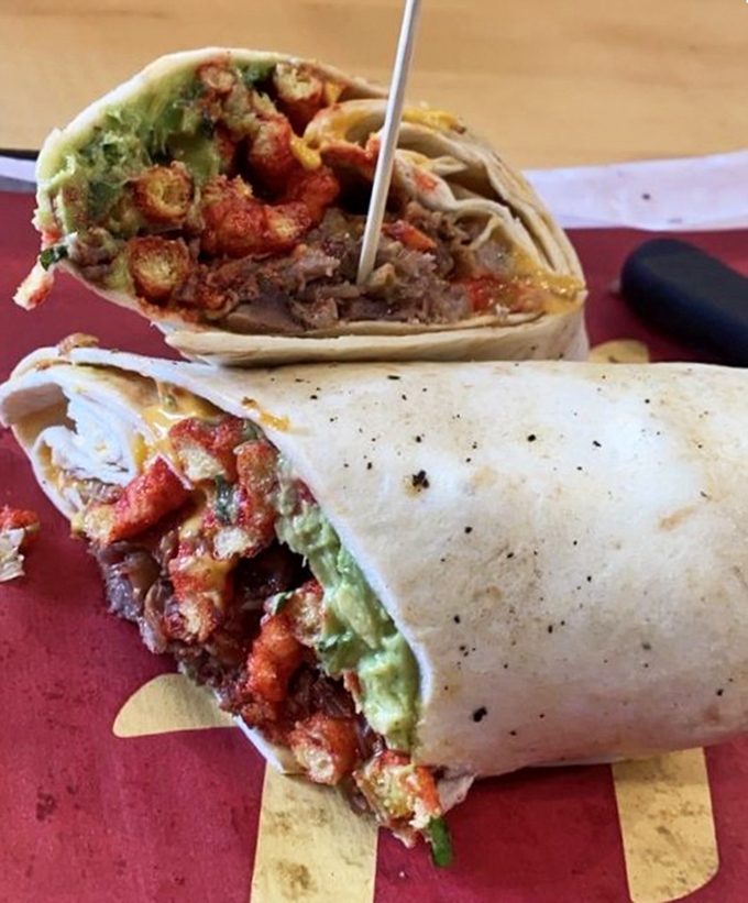 This burrito has more layers than a mystery novel—spicy Cheetos, carne asada, and guacamole create a handheld flavor explosion.