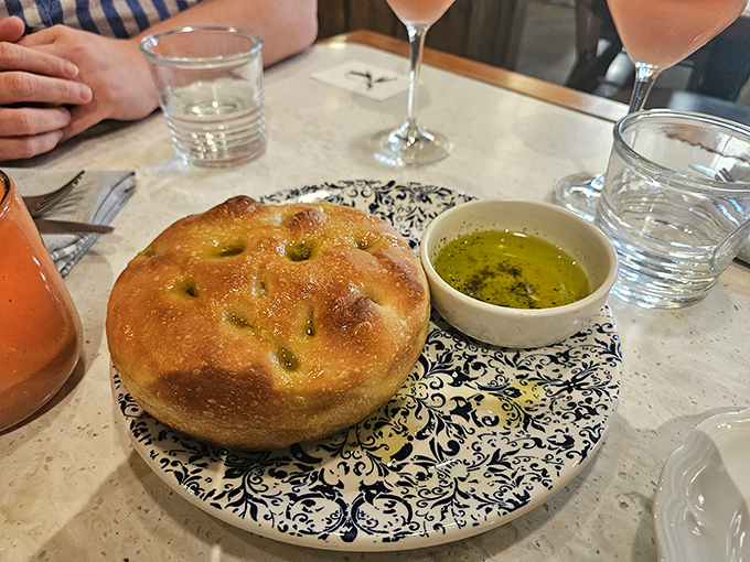 Focaccia that would make an Italian grandmother weep with joy. That glistening pool of olive oil isn't just a condiment&mdash;it's liquid gold for bread-dipping bliss.